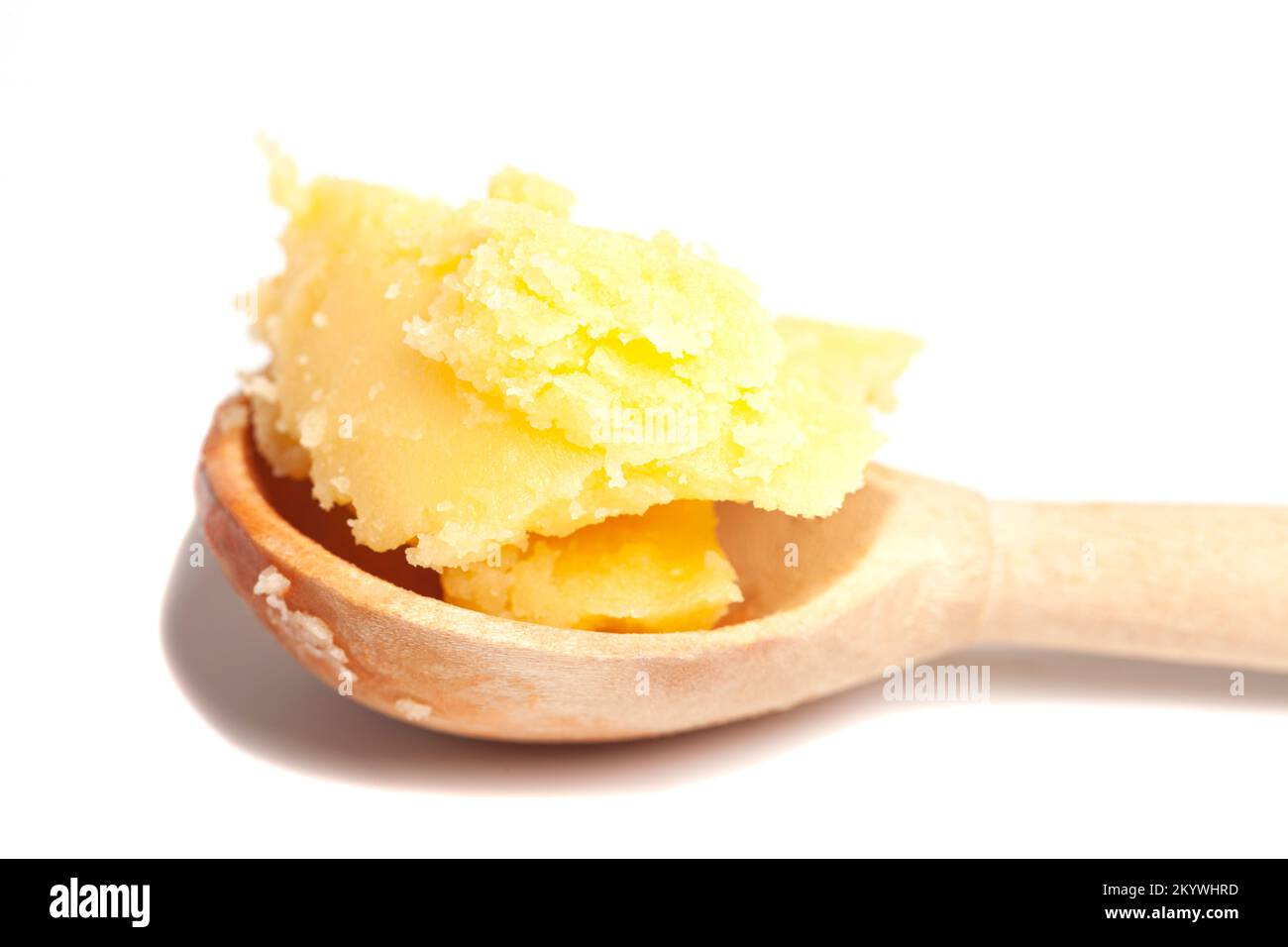 Ghee in wooden spoon isolated on white background Stock Photo - Alamy