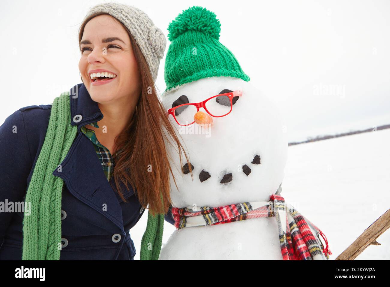 Winter, snow and happy woman hugging a snowman on Christmas outside in ...