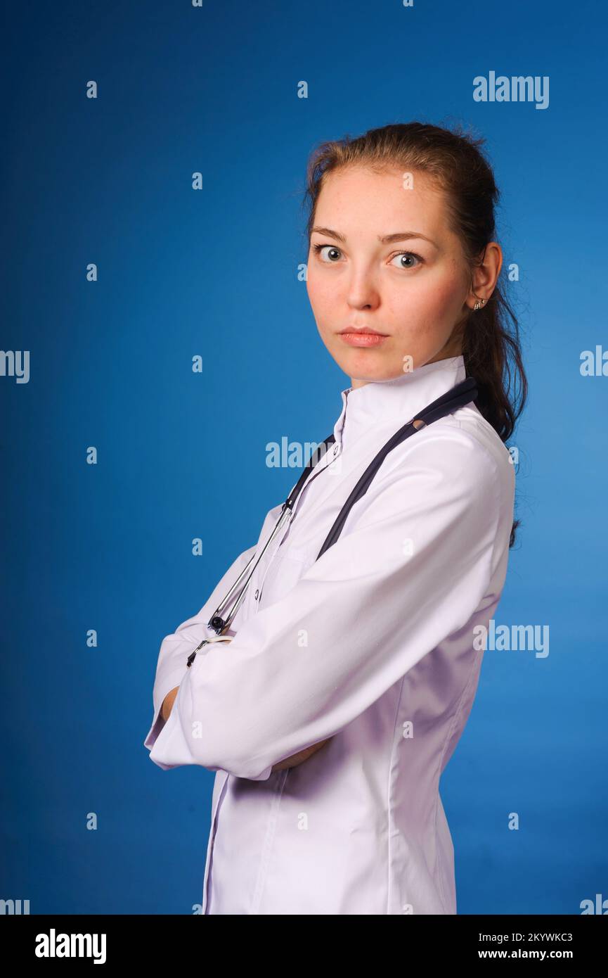 Studio portrait of young intern against blue backgound Stock Photo - Alamy