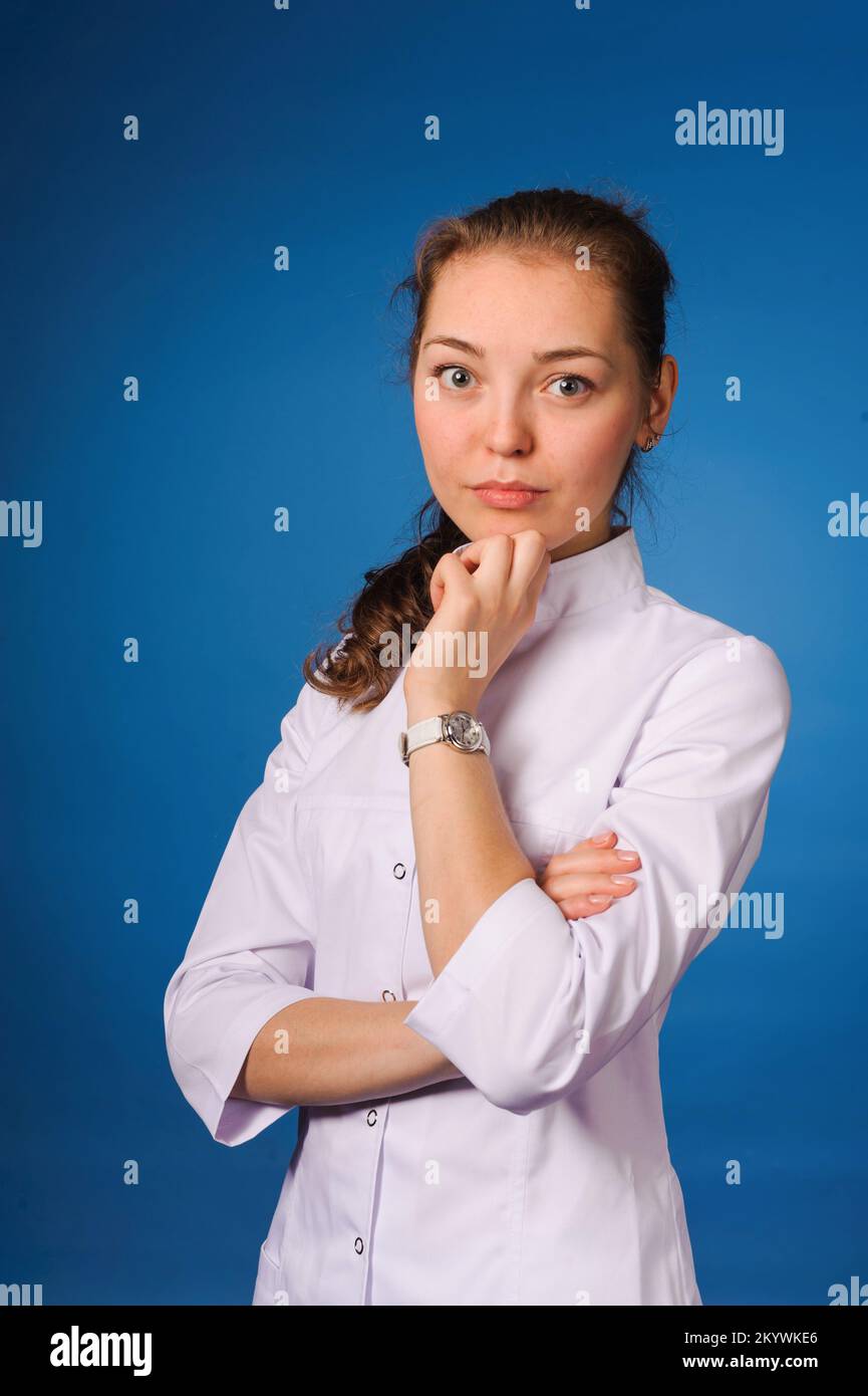 Studio portrait of young intern against blue backgound Stock Photo - Alamy