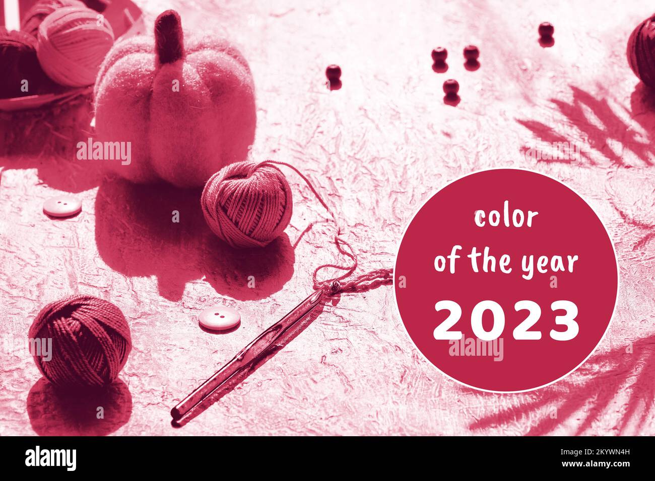 Viva Magenta color of the year 2023. Yarn balls, crochet hook with ...
