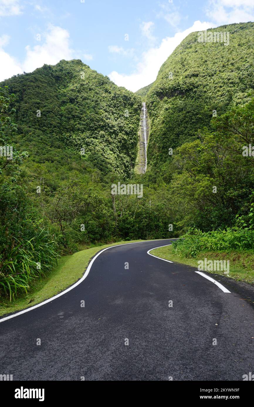 tall waterfall and highway on the tropical island of La Réunion, France ...