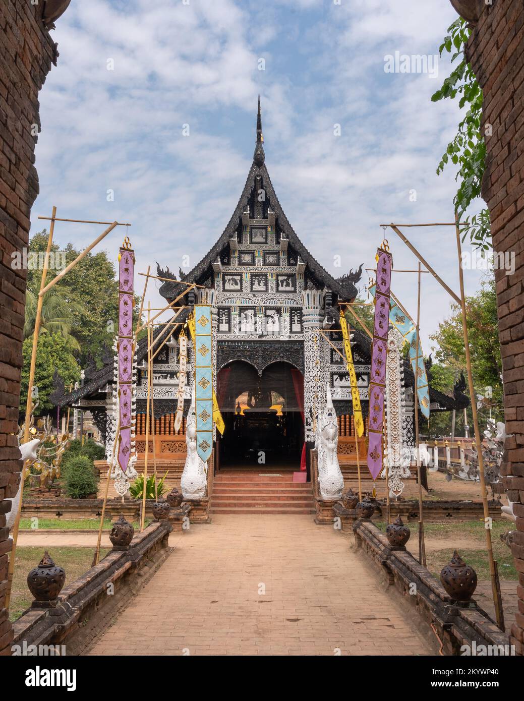 Vertical View Of Ancient Lanna Style Wooden Vihara Through Entrance Gate Walls At Historic Wat