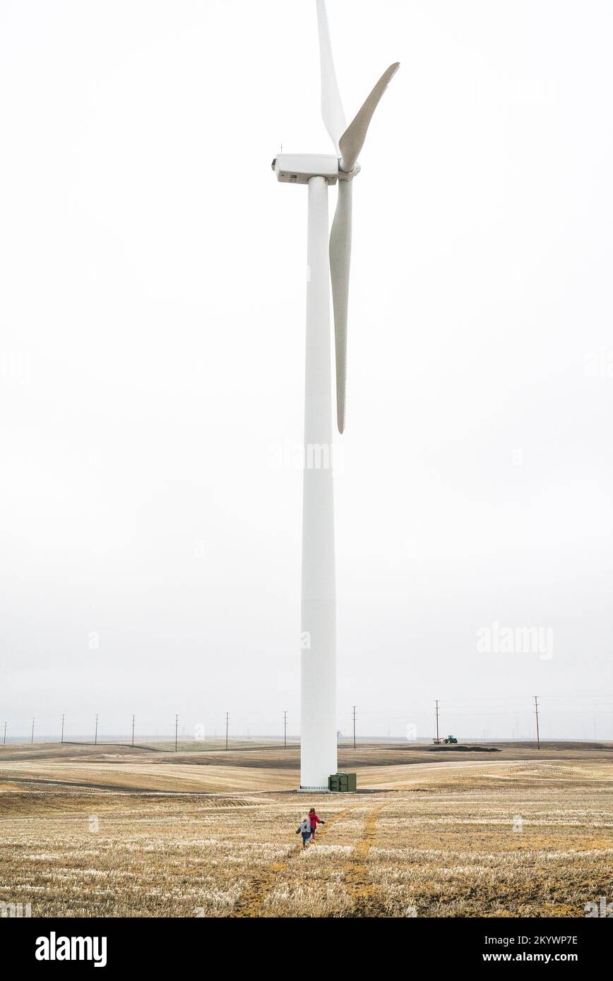 Two children walk toward a giant windmill Stock Photo - Alamy