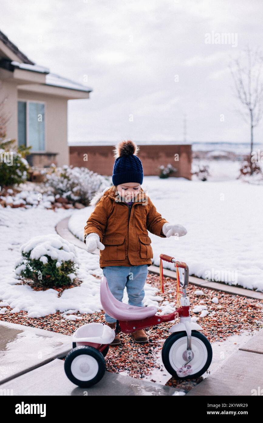 Happy child riding tricycle hi-res stock photography and images - Alamy
