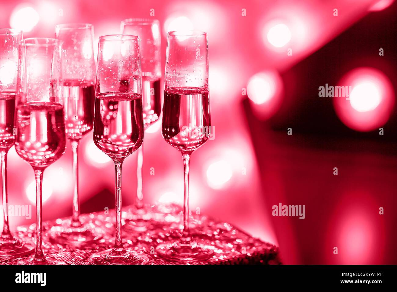 Transparent wineglasses with champagne placed on blurred background of ...
