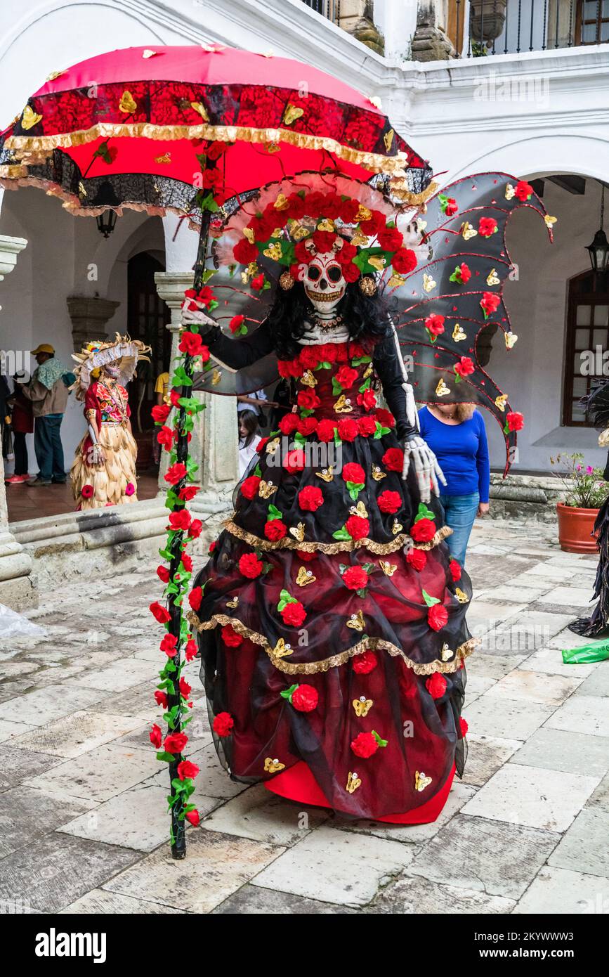 A person on stilts dressed as La Catrina for a costume competition for ...