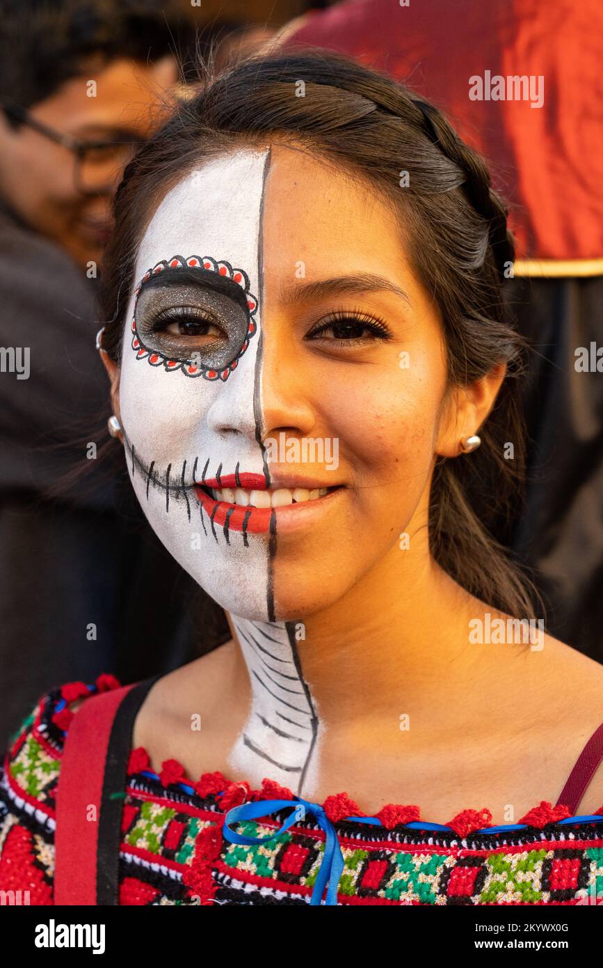 A young woman with her face painted for the Day of the Dead celebration ...