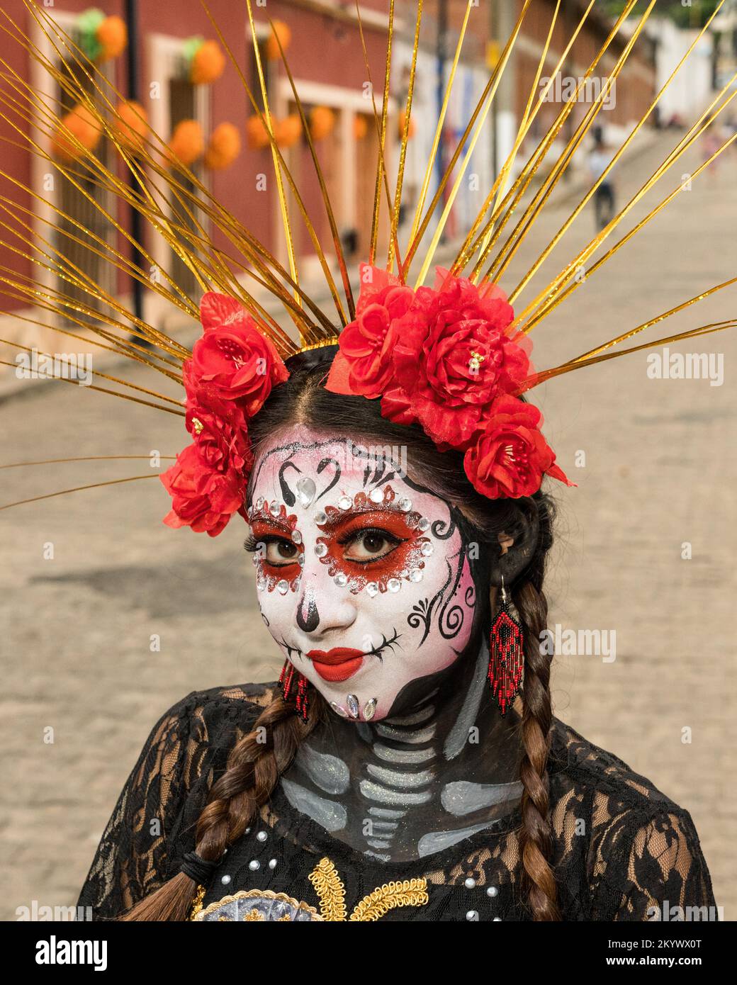 A young woman with her face painted for the Day of the Dead celebration ...