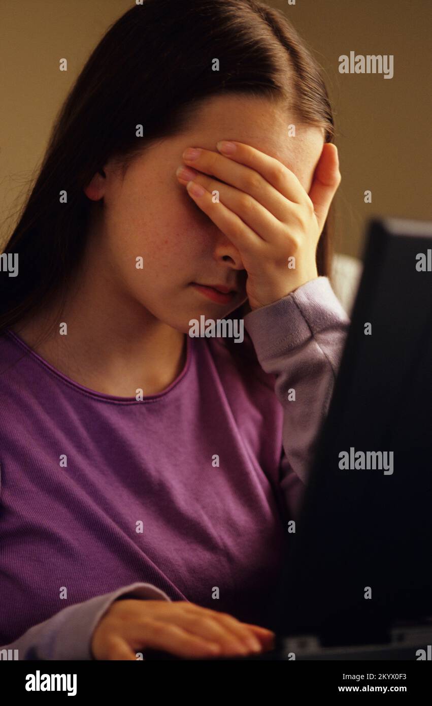 Young girl on computer when something horrible happens Stock Photo - Alamy