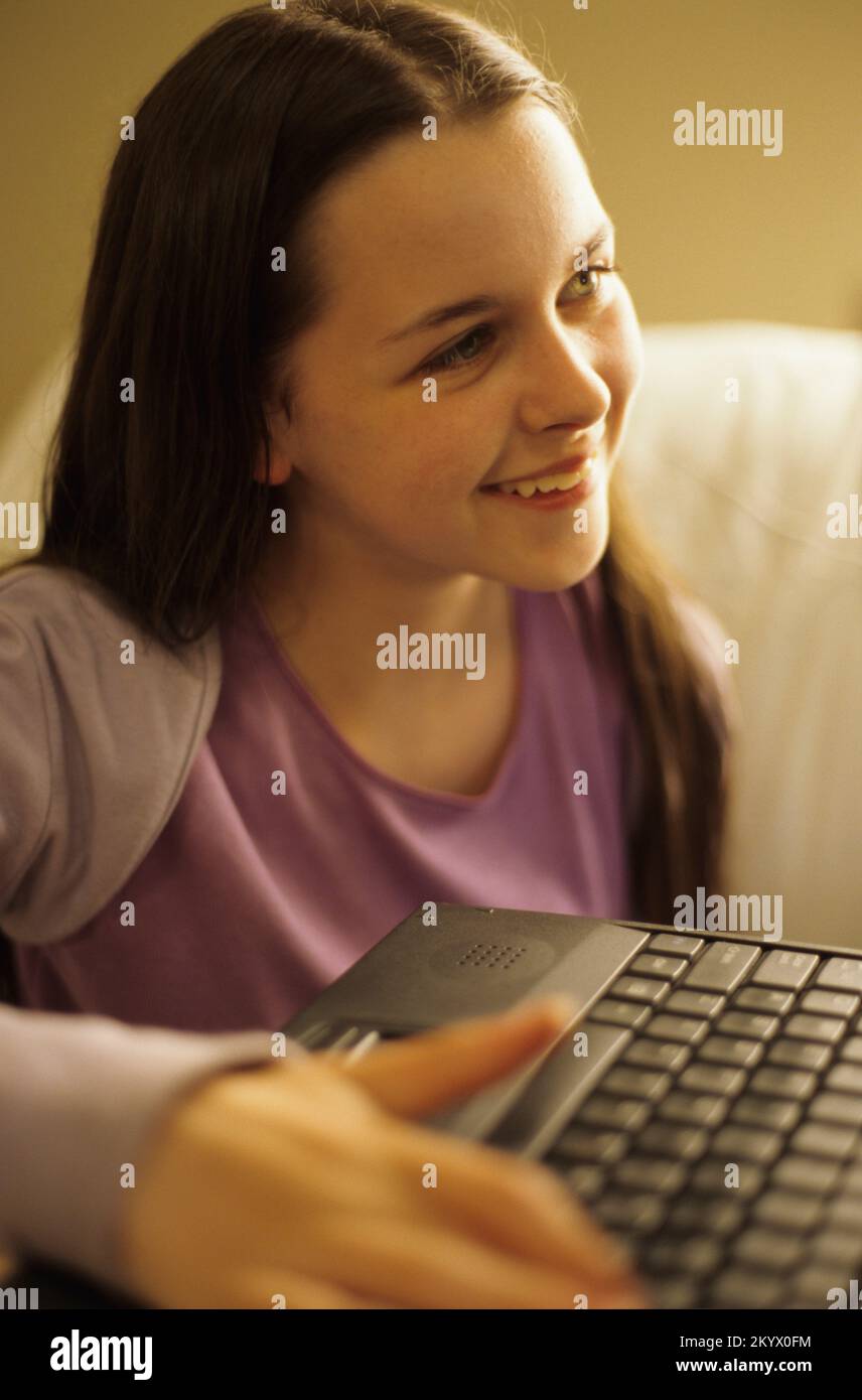 Young girl on computer smiling while studying Stock Photo - Alamy