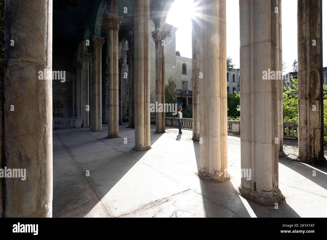 Woman tourist between pillars exploring spectacular abandoned ex soviet ... Woman tourist between pillars exploring spectacular abandoned ex soviet ...