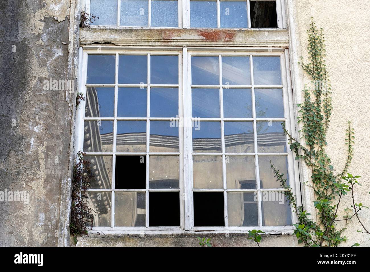 Reflection in an old window of a spectacular abandoned ex soviet ...