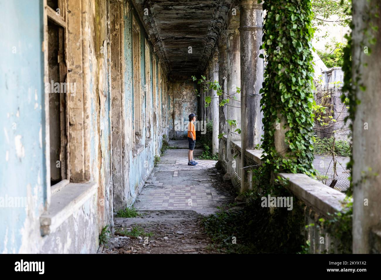Boy tourist exploring spectacular abandoned ex soviet complex of ...