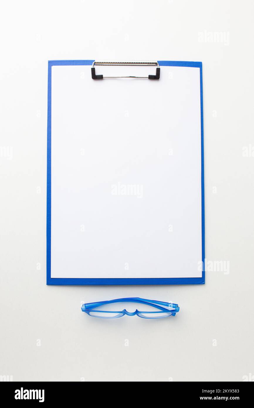 Empty file folder on white desk with glasses for sight. Top view Stock ...