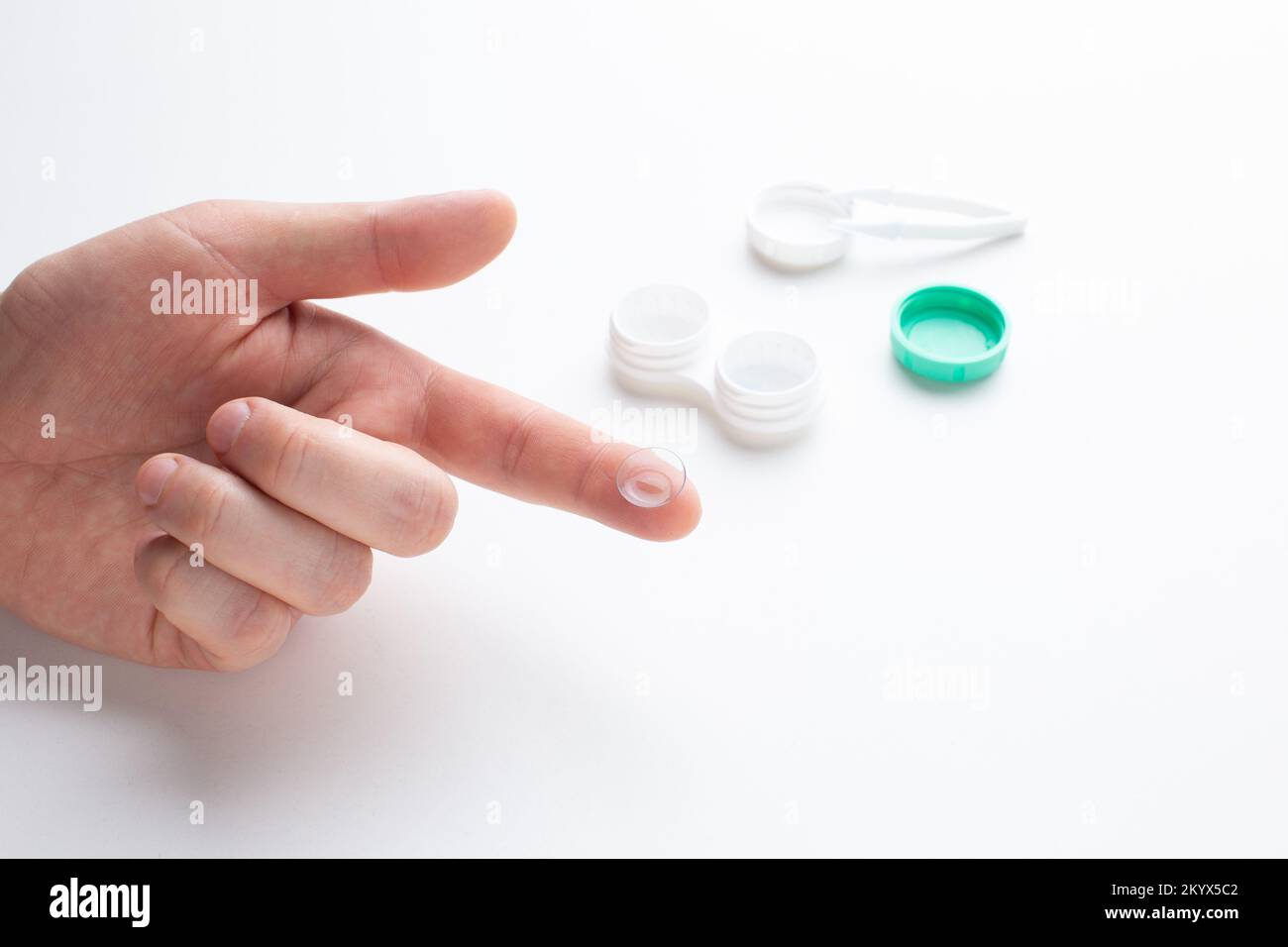 The man on the background of the containers for storing contact lenses ...