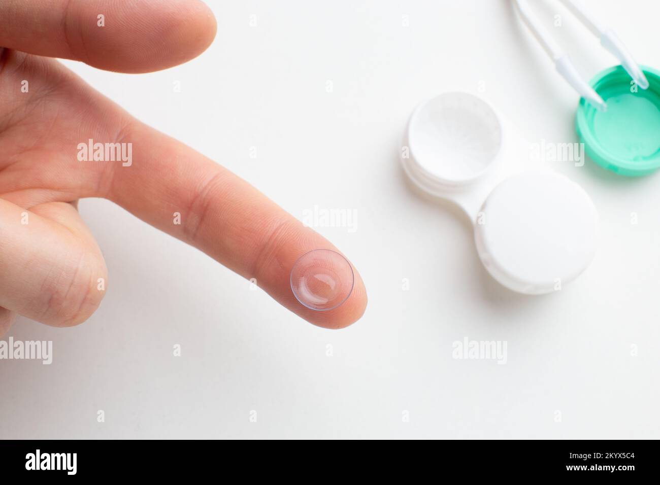 The man on the background of the containers for storing contact lenses ...