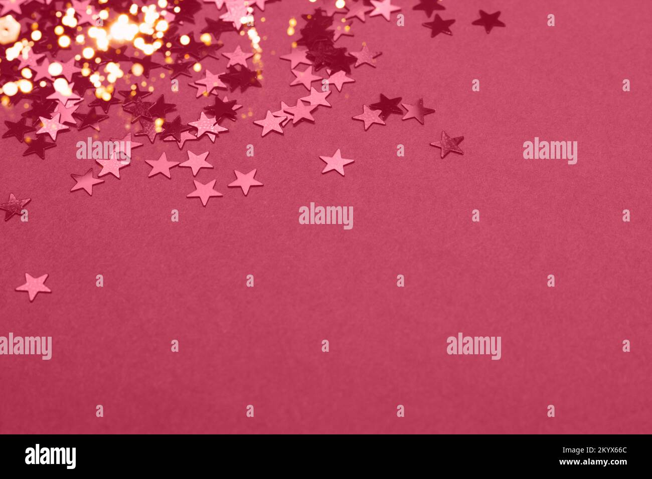 Metallic confetti on festive magenta paper background Stock Photo - Alamy