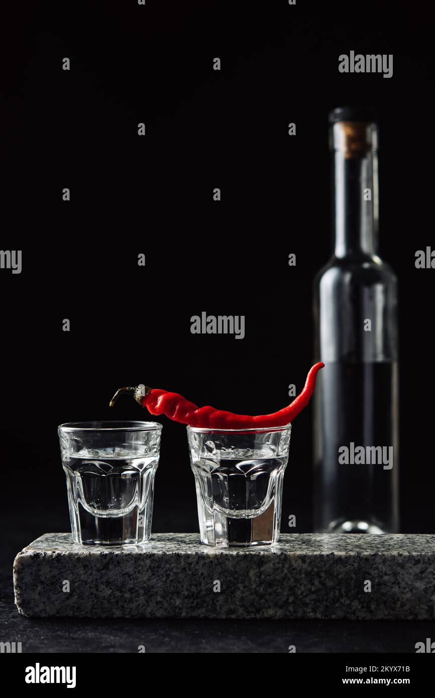 Two shots of vodka with red hot pepper Stock Photo - Alamy