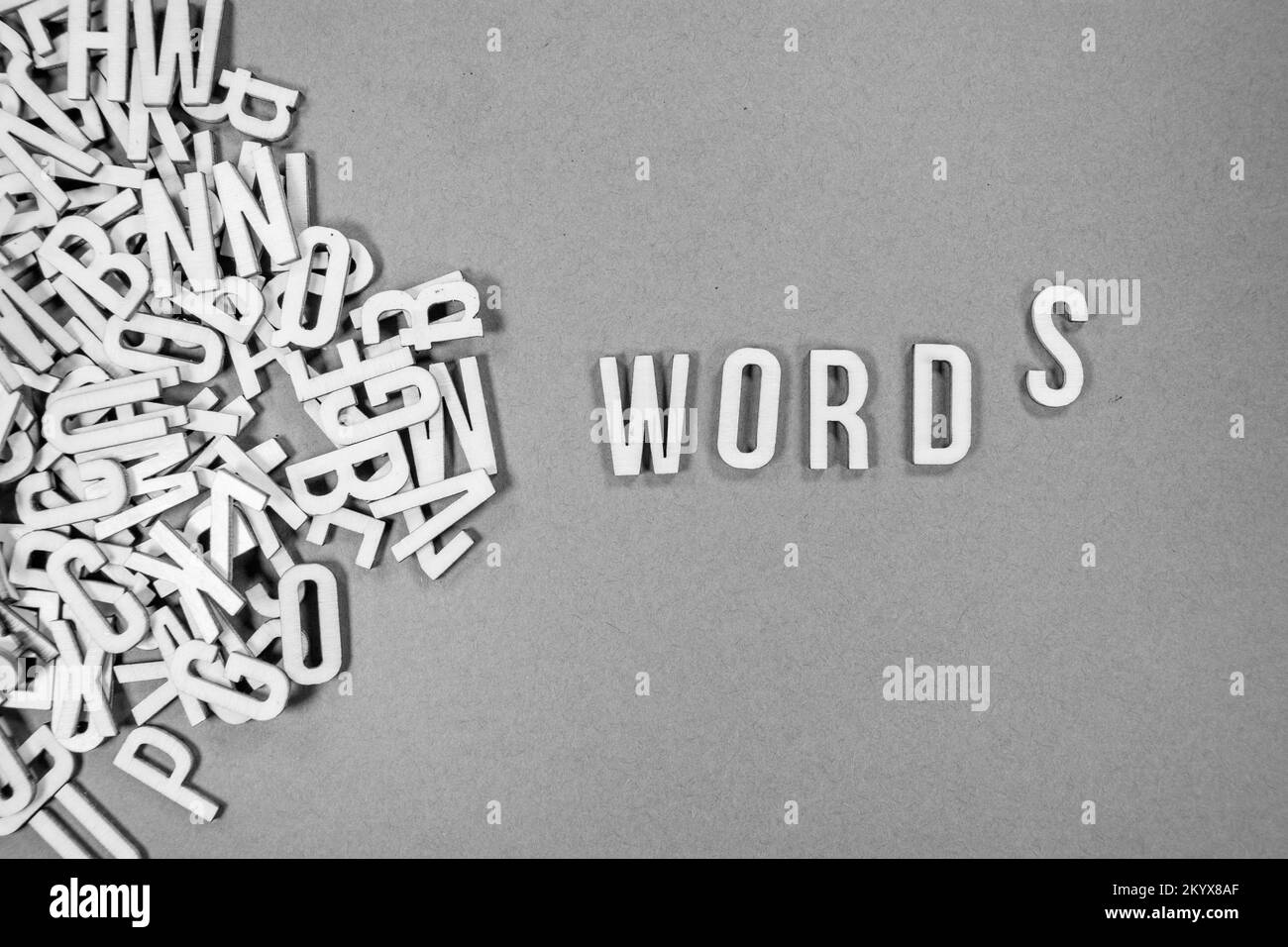 background with a pile of wooden capital letters spilling into words ...