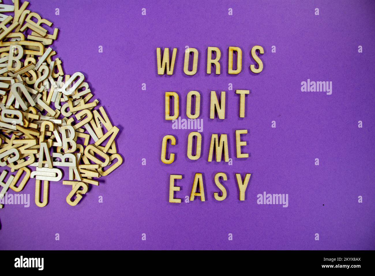 background with a pile of wooden capital letters spilling into words ...