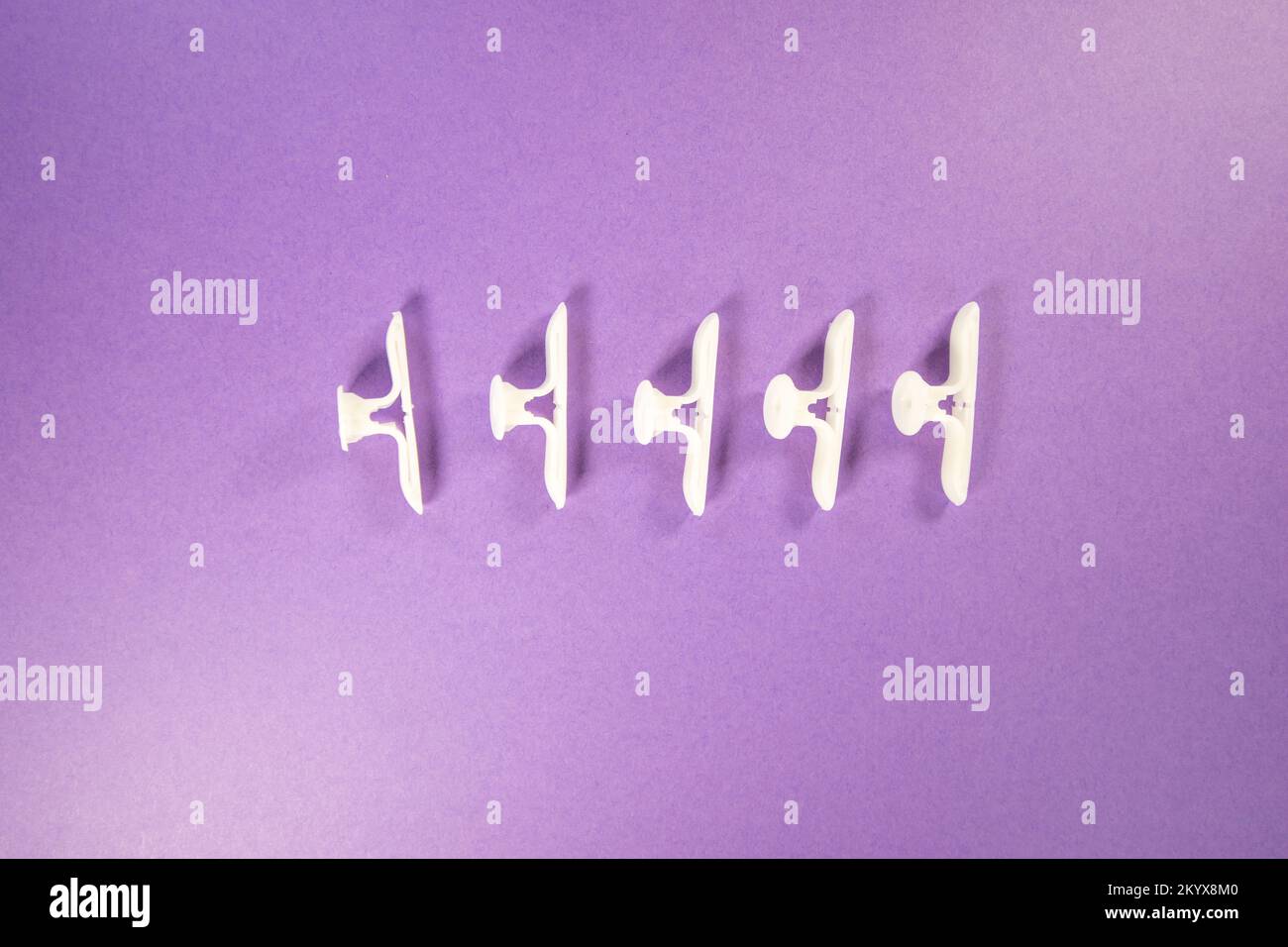 line of five plastic toggle fixings for plasterboard hollow walls ...