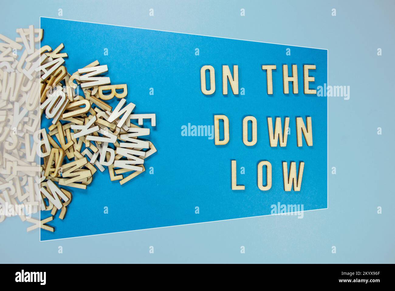 ON THE DOWN LOW in wooden English words language capital letters ...
