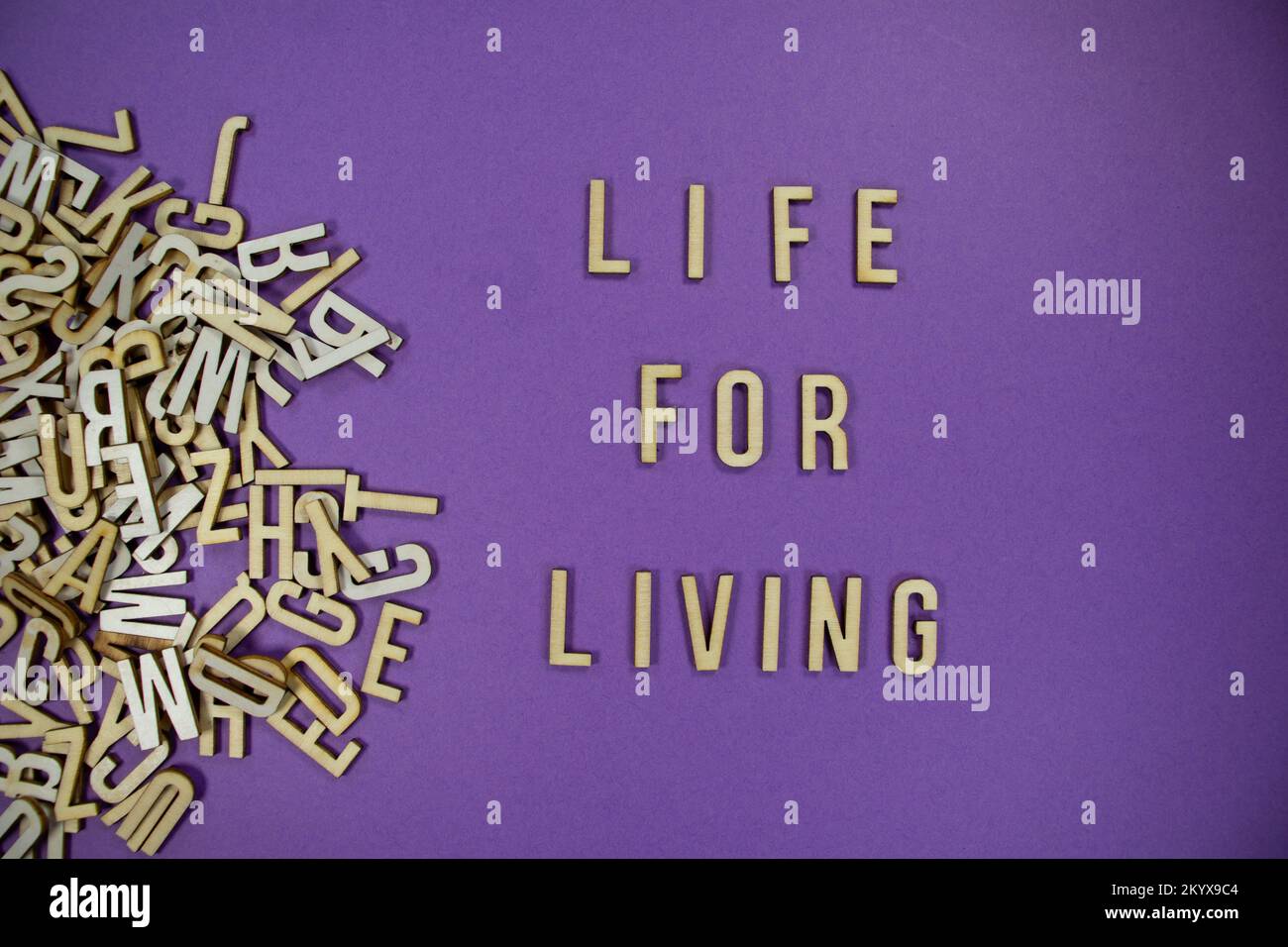 pile of wooden English language capital letters spilling into words ...