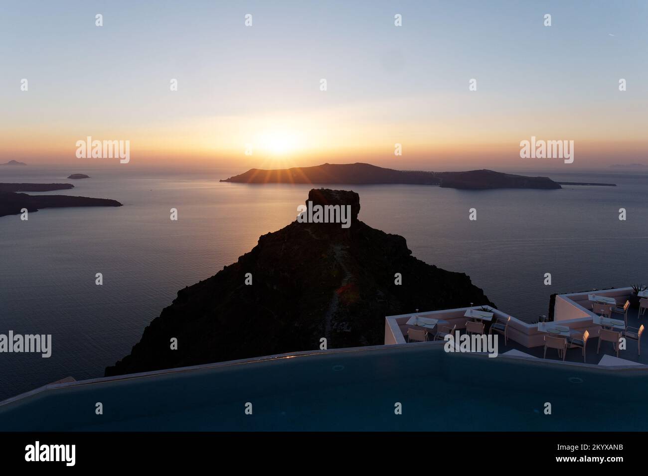 Sun setting over Thirasia with Skaros Rock foreground. Aegean Cyclades ...