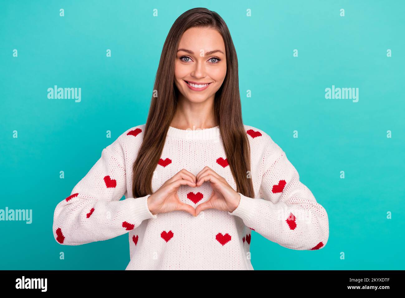 Portrait of adorable cheerful girl hands showing heart gesture toothy ...