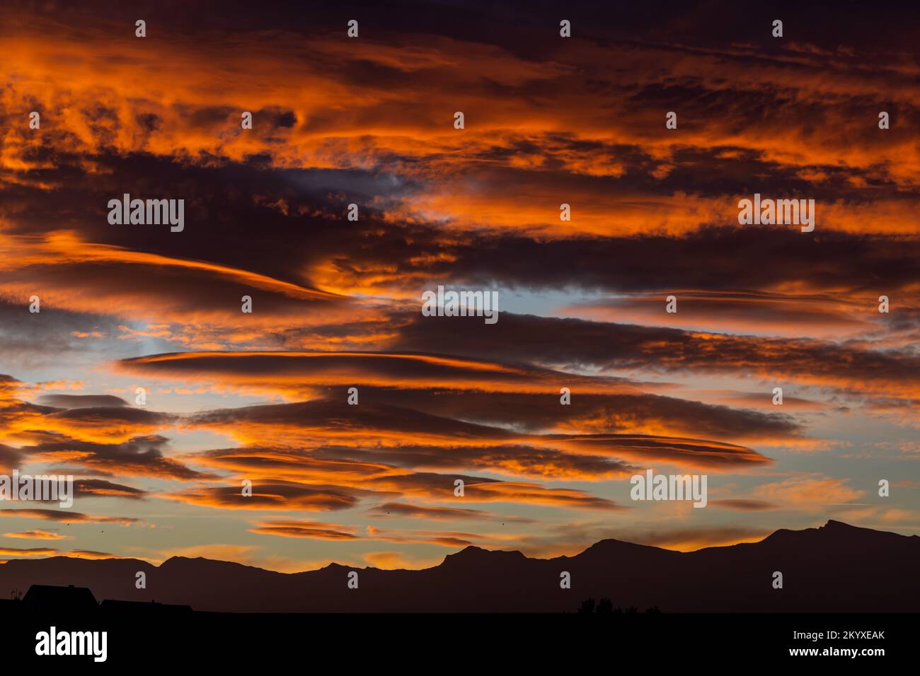 Spectacular lenticular clouds at dawn over the silhouette of the Sierra ...