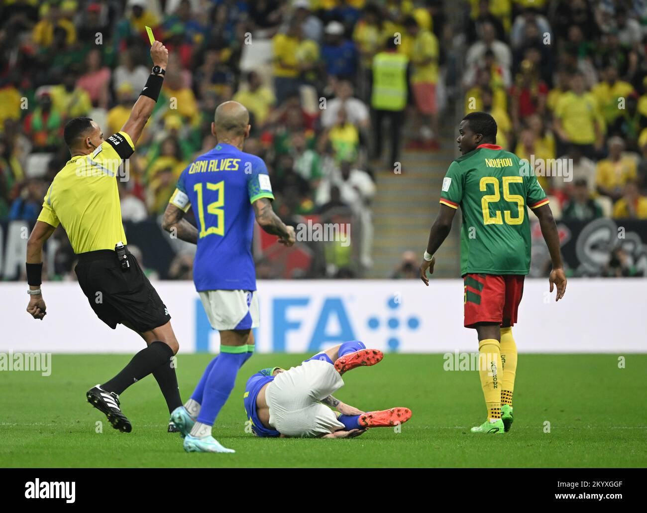Lusail, Qatar. 2nd Dec, 2022. Referee Ismail Elfath (L) gives a yellow ...