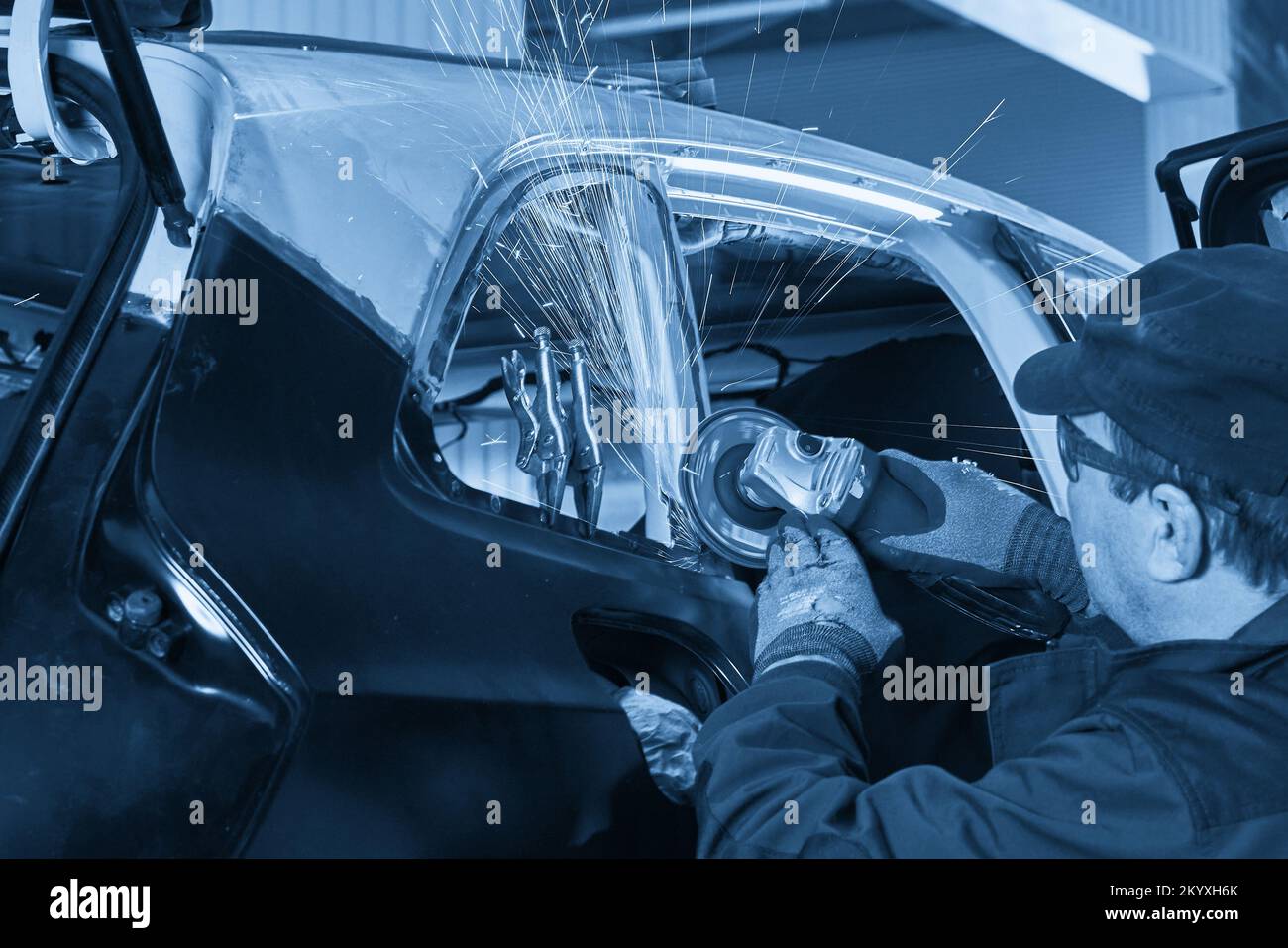 Repair service worker fix damaged car. Working with angle grinder to ...