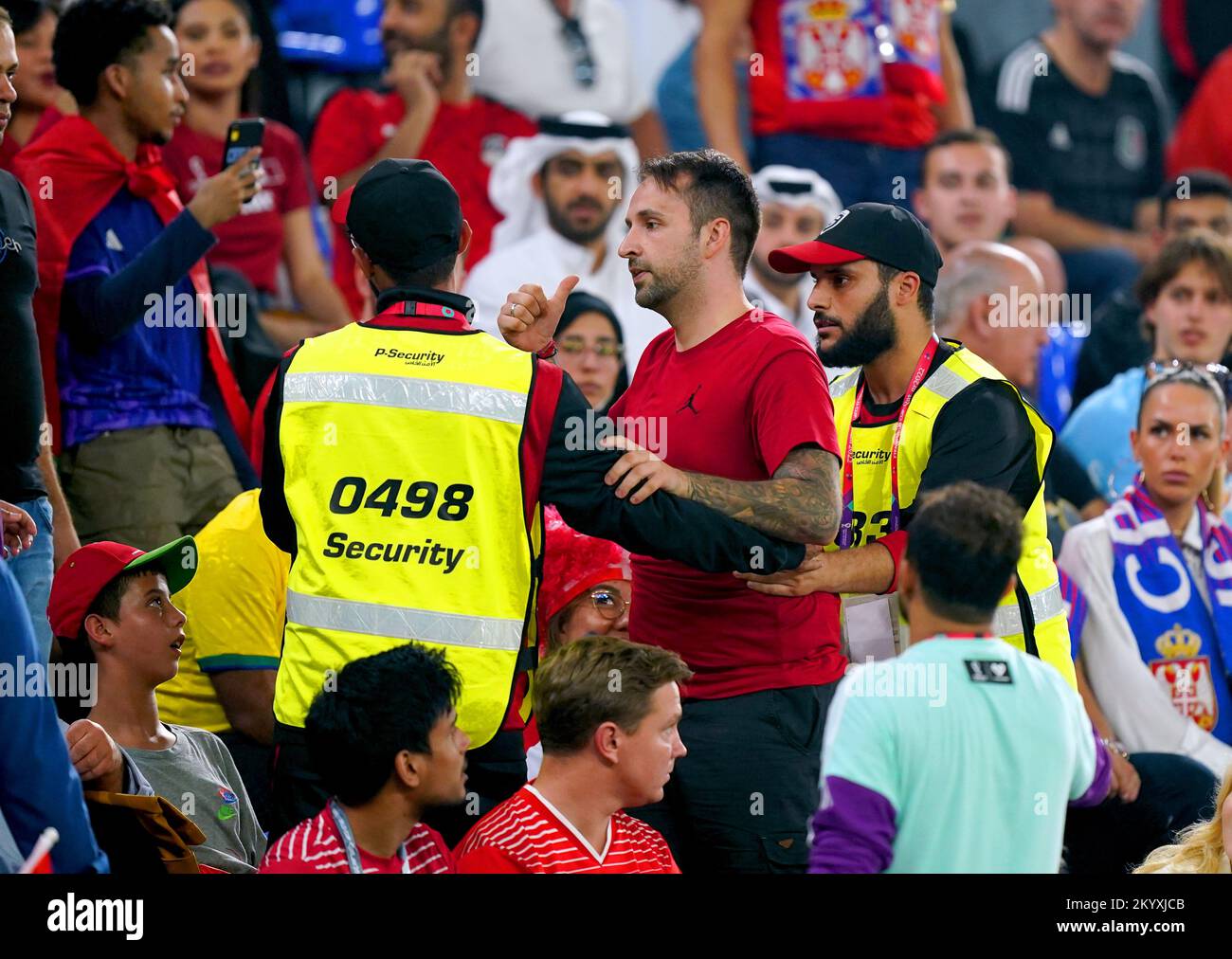 Security remove a fan from the stands during the FIFA World Cup Group G ...