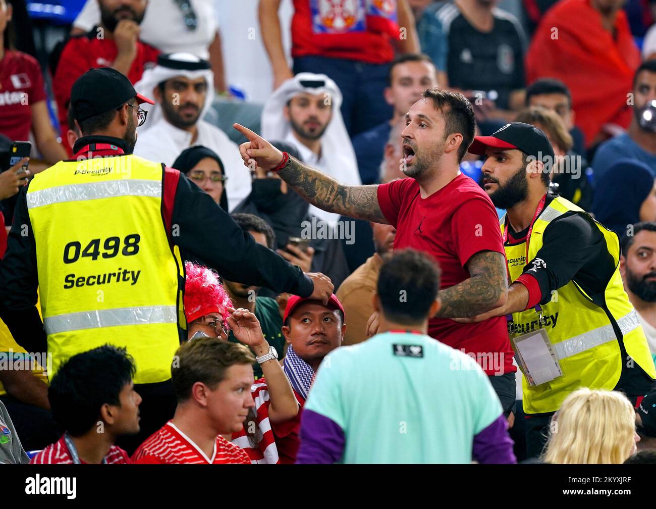 Security remove a fan from the stands during the FIFA World Cup Group G ...