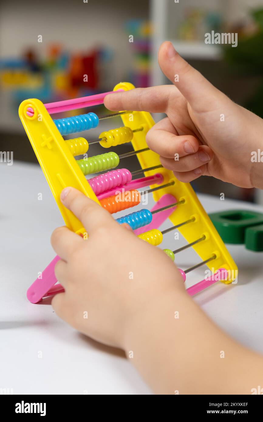 A small child learns to count on abacus, mathematics, arithmetic for ...