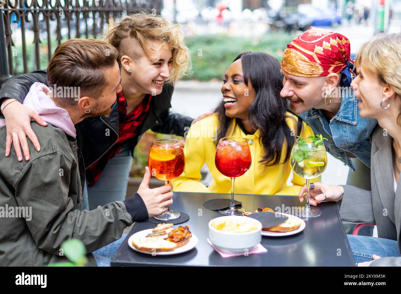 Multicultural happy friends having fun at pub outdoors - Young people ...