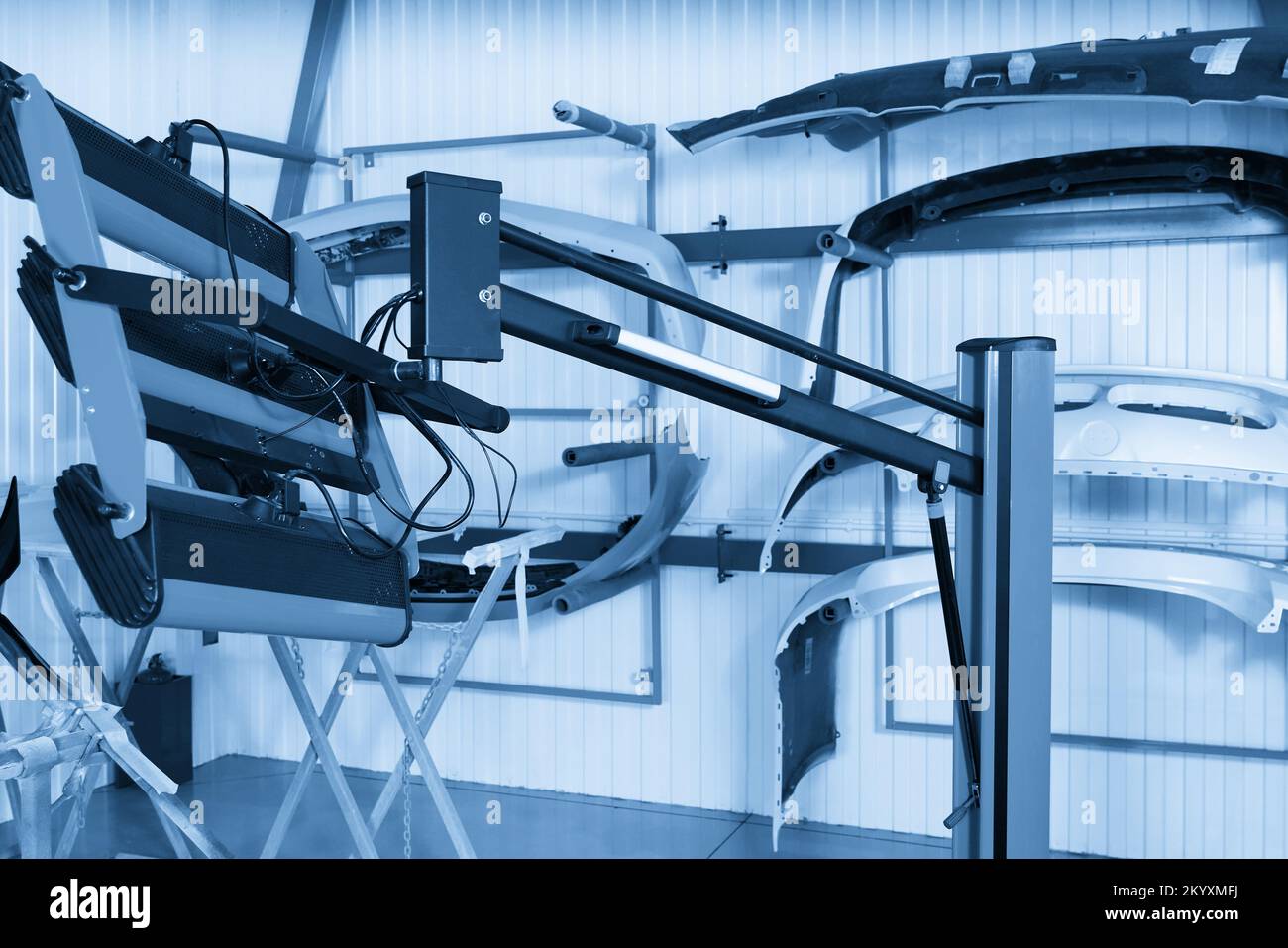 Painting and drying under lamps in professional box of car body parts ...