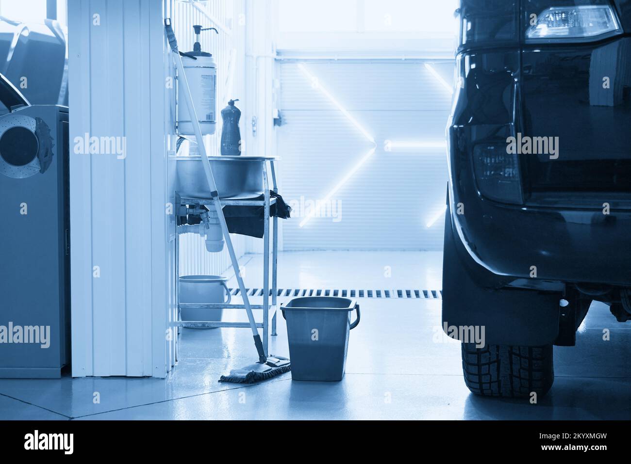 cleaning floor in car workshop, keeping work place clean Stock Photo ...