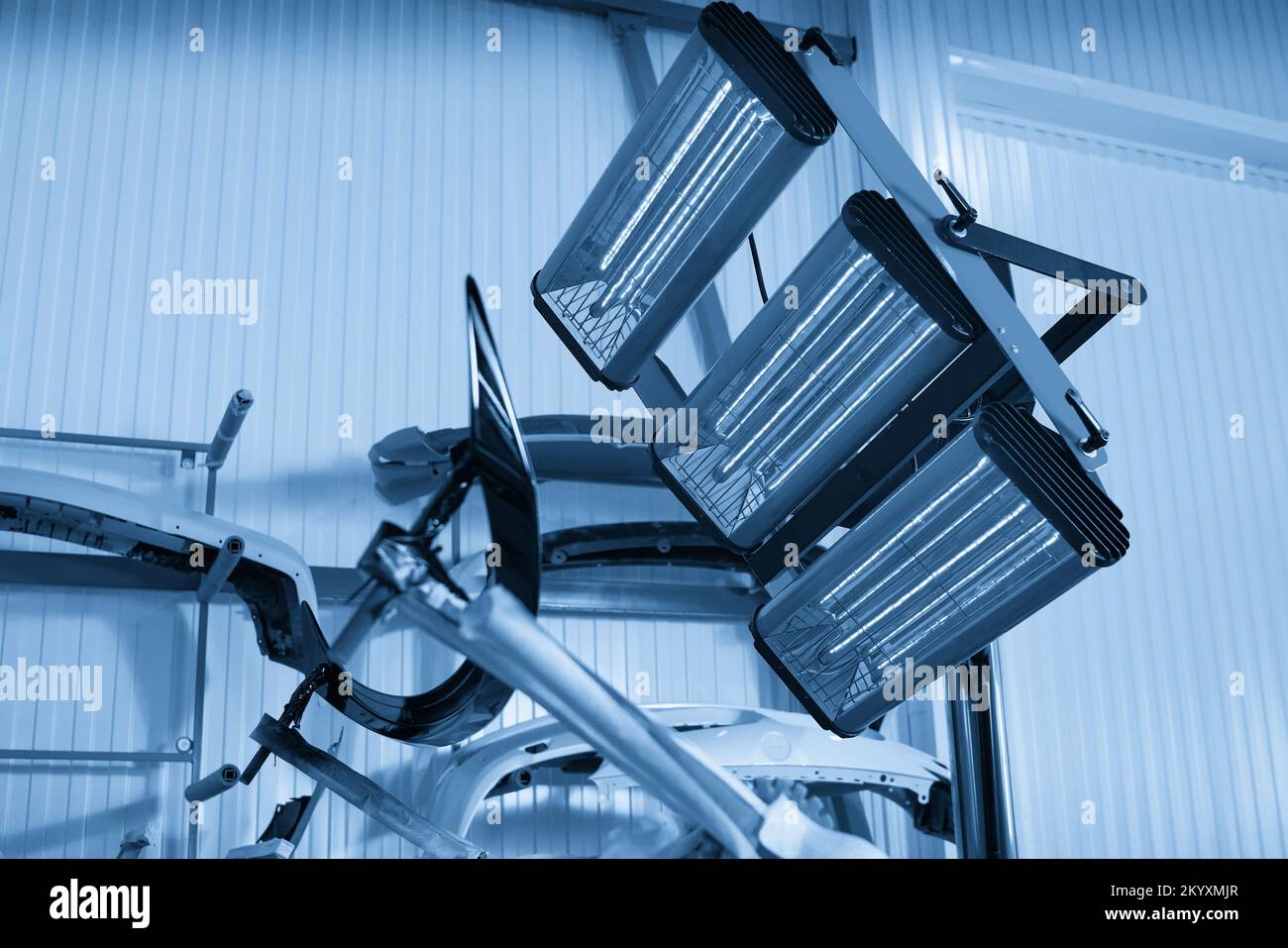 Painting and drying under lamps in professional box of car body parts ...