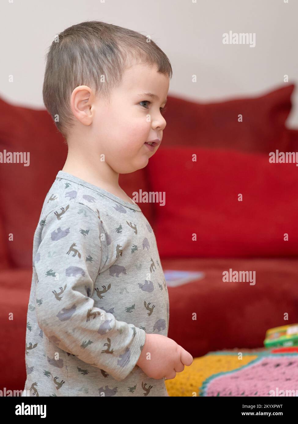 cute toddler playing with a toy camera while watching TV at home Stock ...