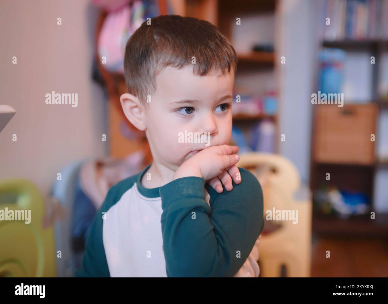 cute young boy watching intently while bending his wrist Stock Photo ...