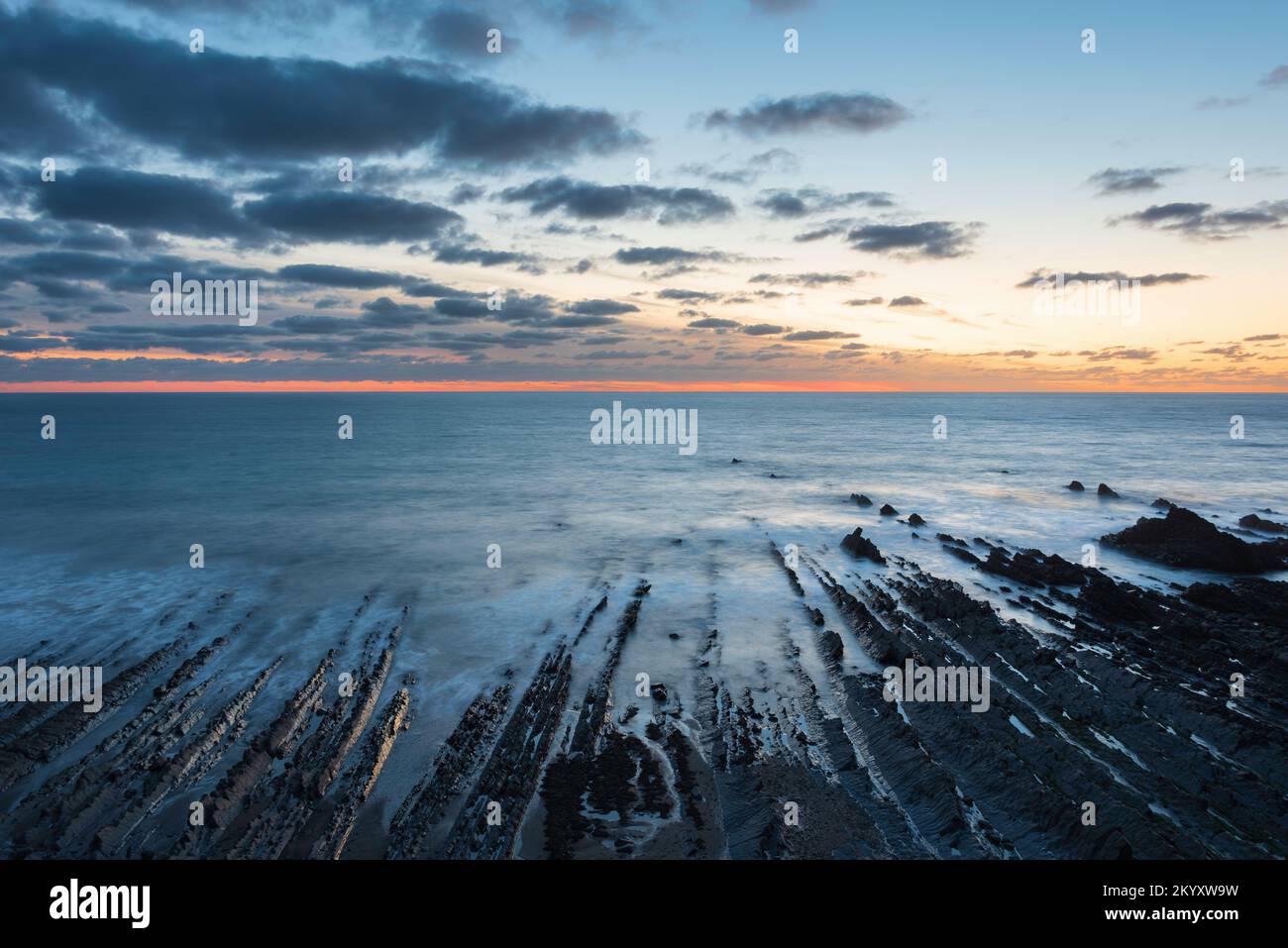 Stunning sunset landscape image of Welcome Mouth Beach in Devon England ...