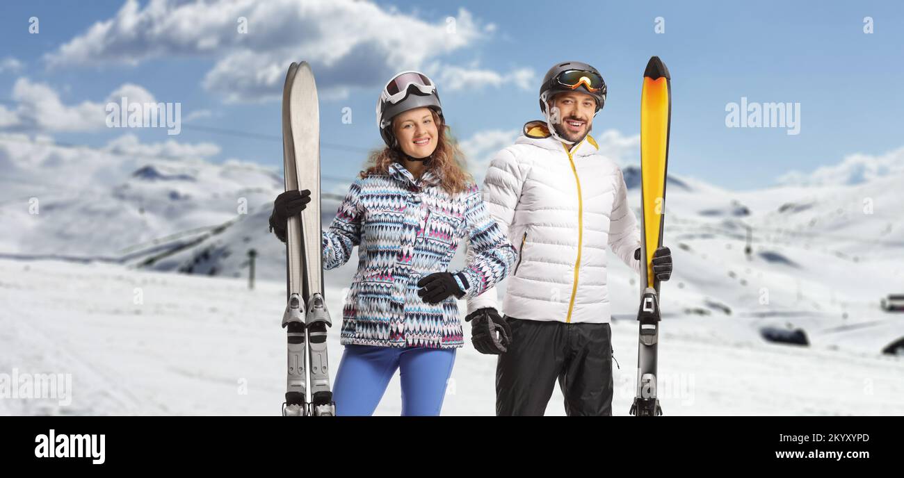 Young couple skiers with helmets and goggles posing on a mountain Stock ...