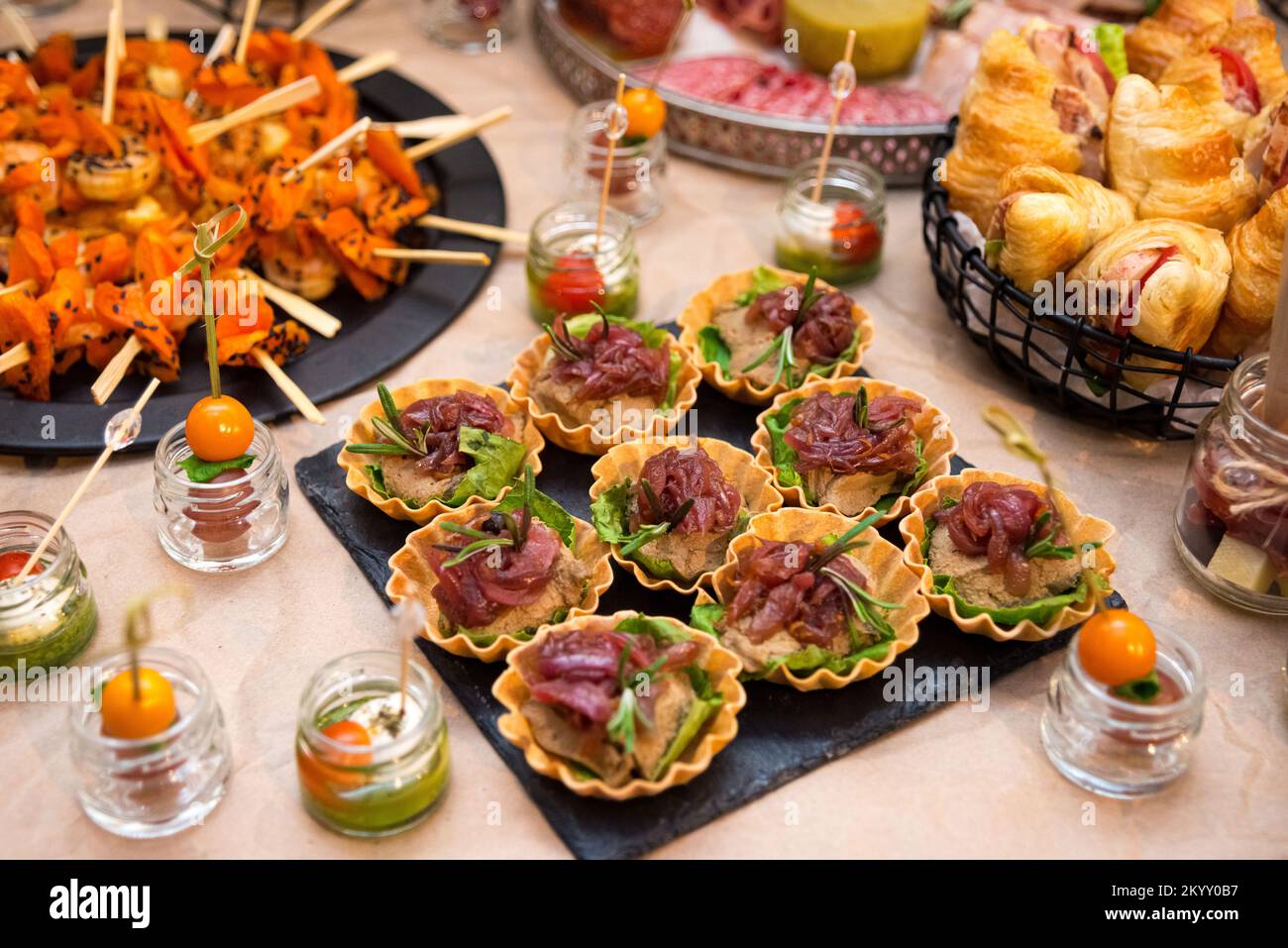 table with lots of appetizers, buffet table, tartlets, appetizers in ...