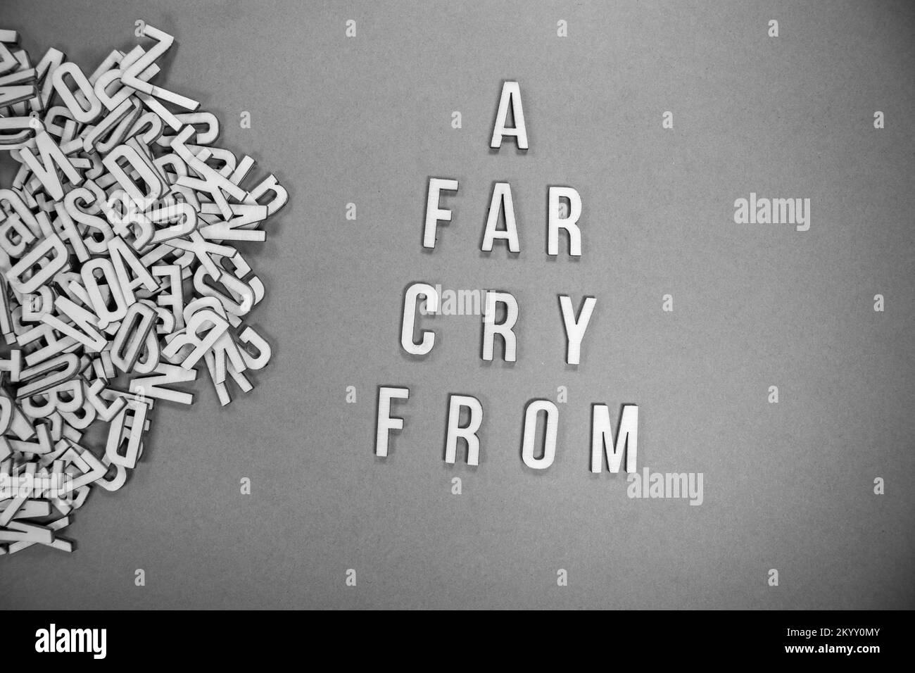 A FAR CRY FROM in wooden English language capital letters spilling from ...