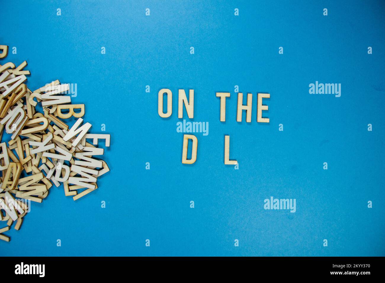 ON THE D L in wooden English language capital letters spilling from a ...