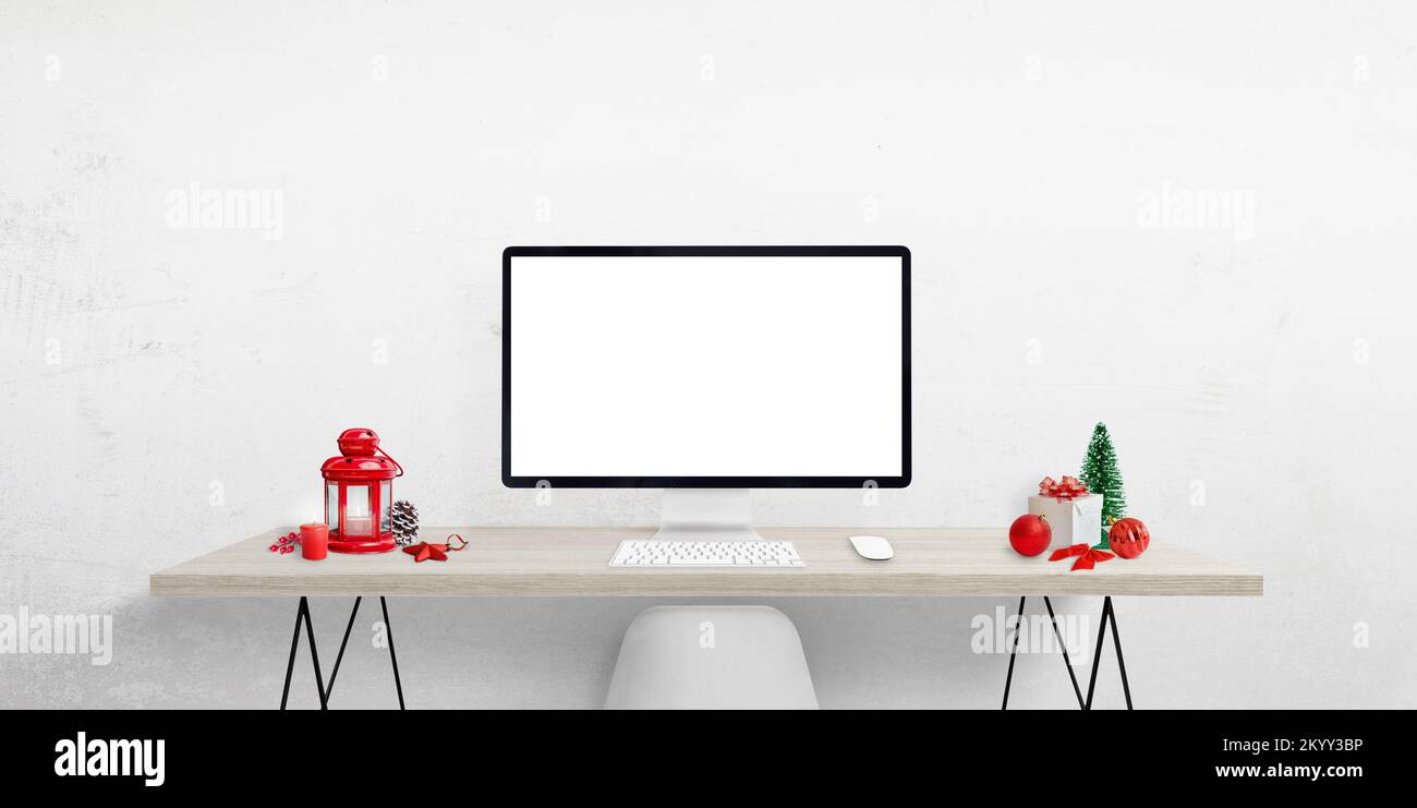 Blank computer display on work desk surrounded by Christmas decorations ...