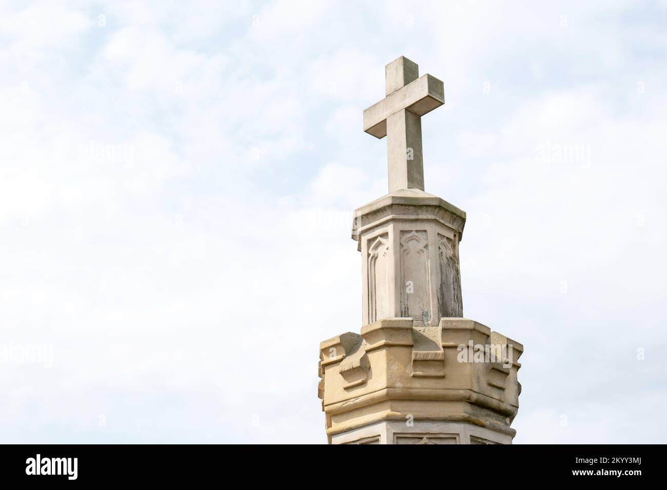 Old stone cross and light blue sky simple abstract background, copy ...