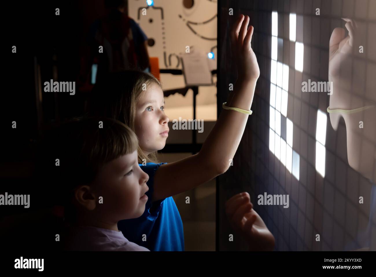 Two elementary school age children, girls interacting with a ...